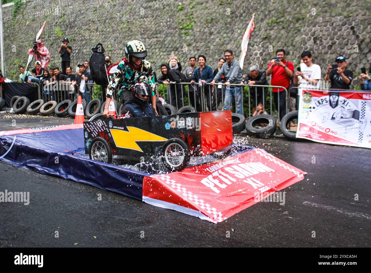 Participants clear the last jump at the Soap Box Derby in Bandung, West ...