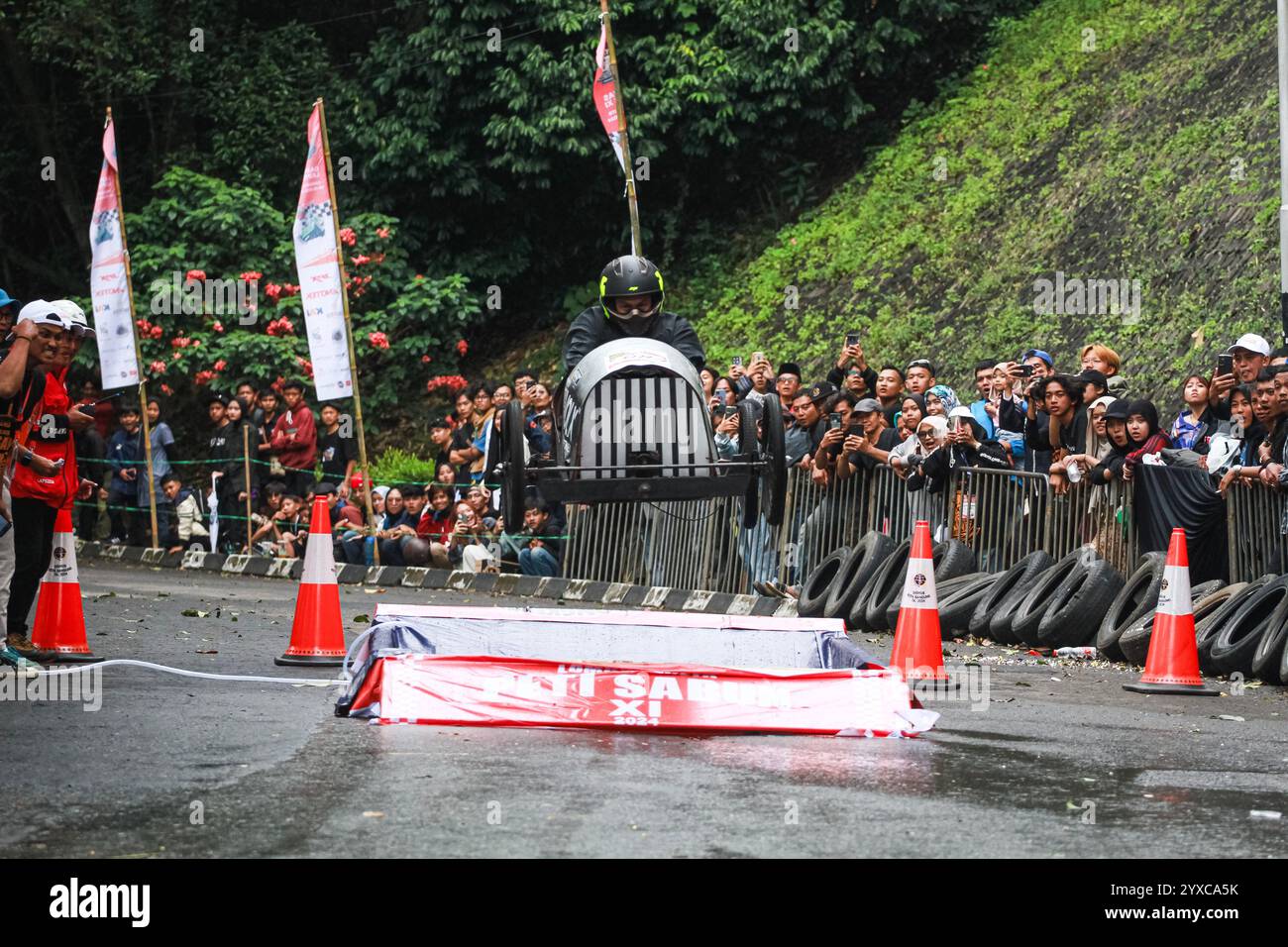 Participants clear the last jump at the Soap Box Derby in Bandung, West ...