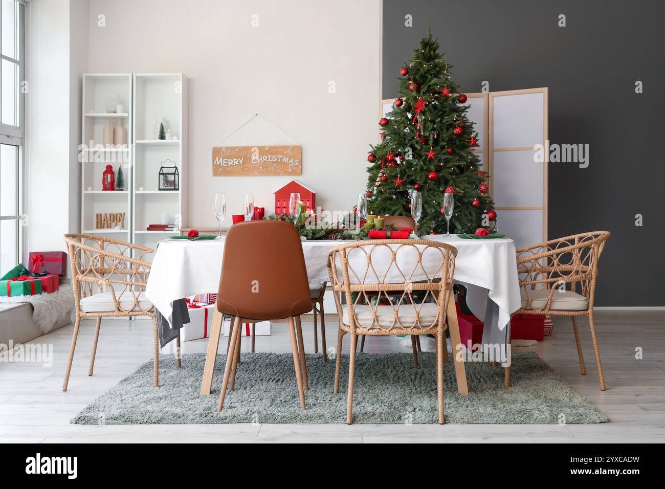 Interior of room with dining table, shelf unit and Christmas tree Stock ...