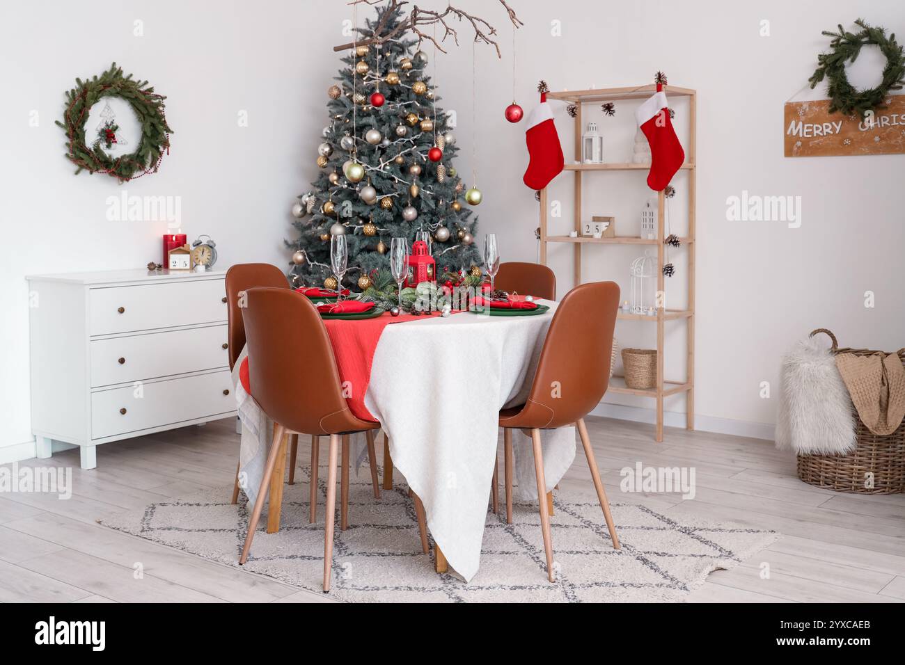 Interior of room with dining table, shelf unit and Christmas tree Stock ...