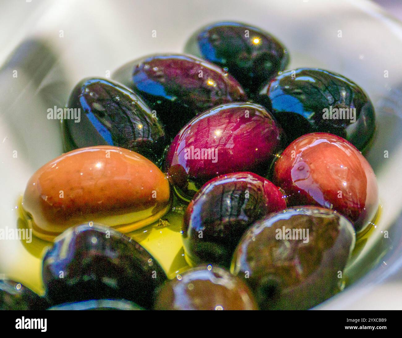 Warm colors of olives in olive oil. Taken in Santorini Stock Photo - Alamy