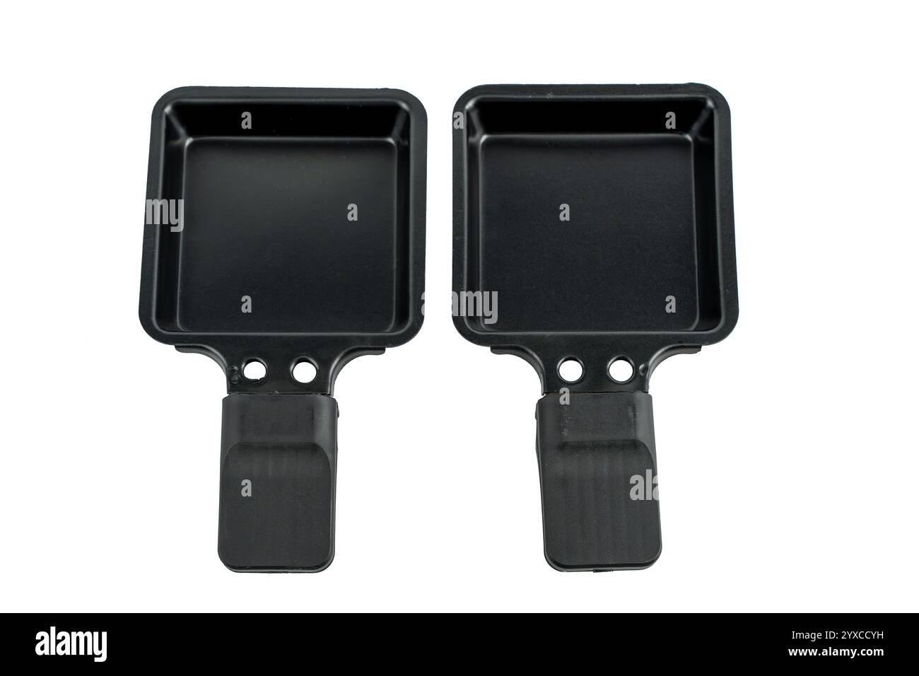 Two empty raclette moulds from processed cheese, close-up. Two empty ...