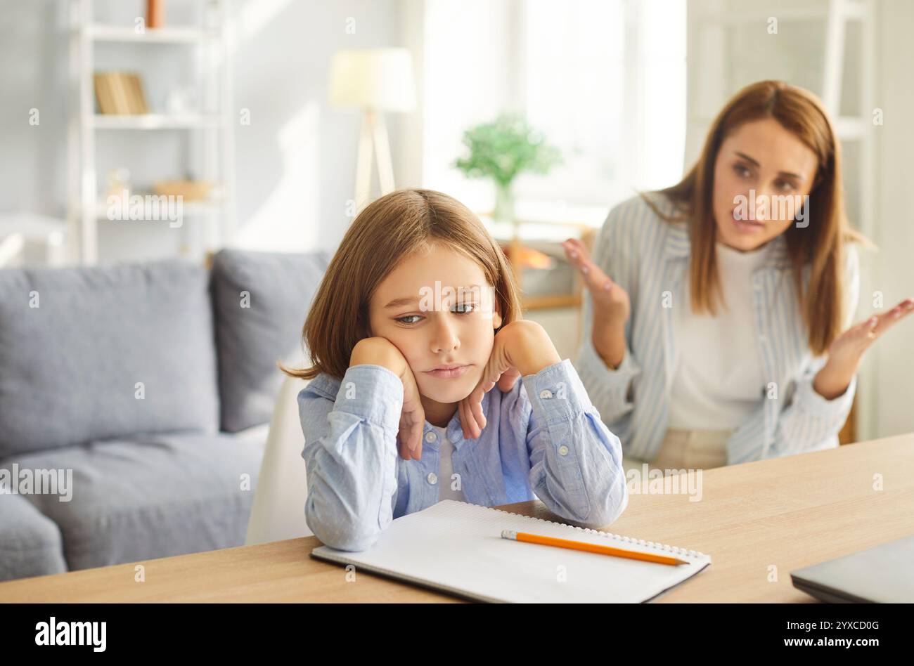 Angry adult mother scolding little child boy for bad school results at ...