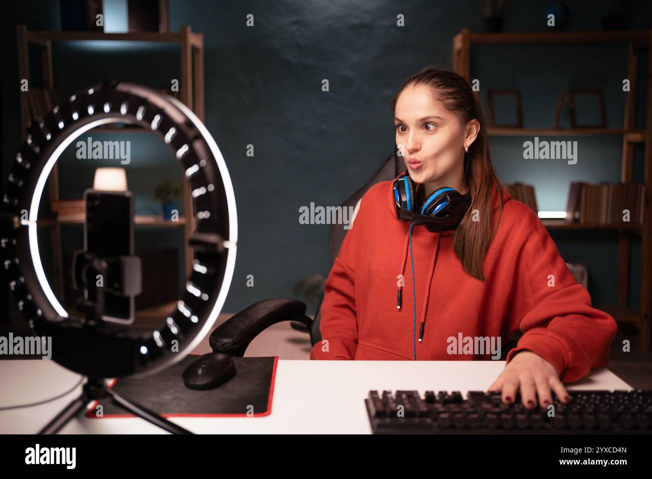 Female blogger streamer gamer live streaming online making fish face ...