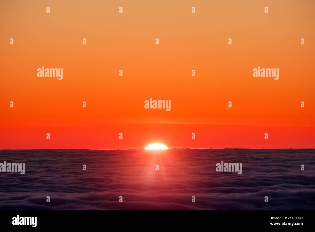 Scenic view of sun rising over clouds horizon, vivid colorful skyline ...