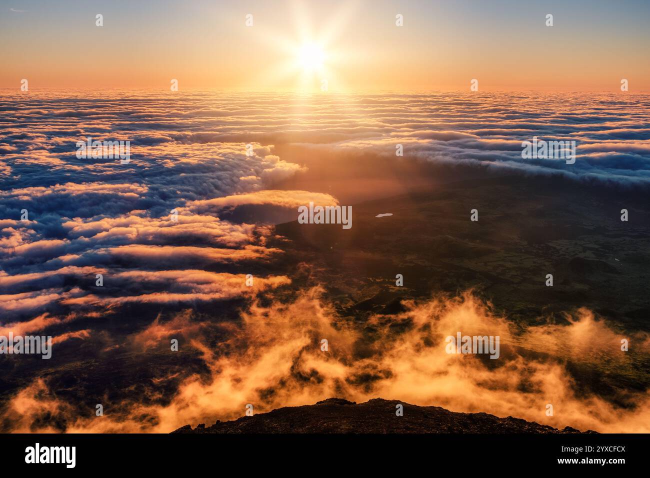Colorful moody sunrise with clouds and volcanic rocks and steam ...