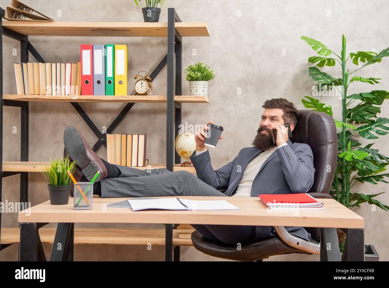 Rest when you need it. Happy businessman drinking coffee during phone ...