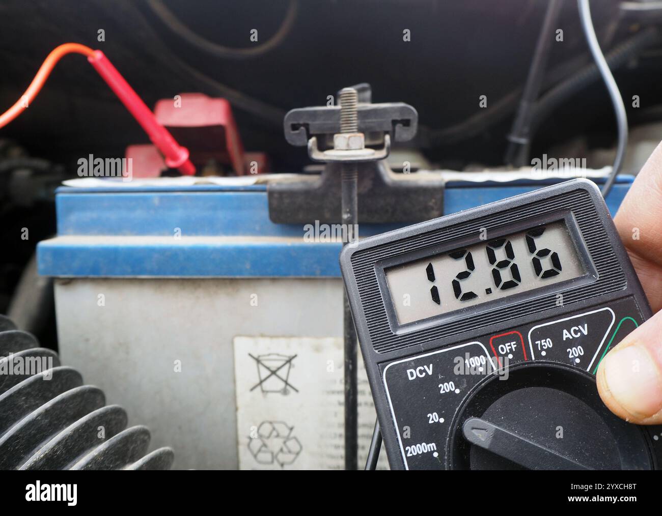 Checking battery charge levels with a voltmeter. Measuring car battery voltage Stock Photo - Alamy