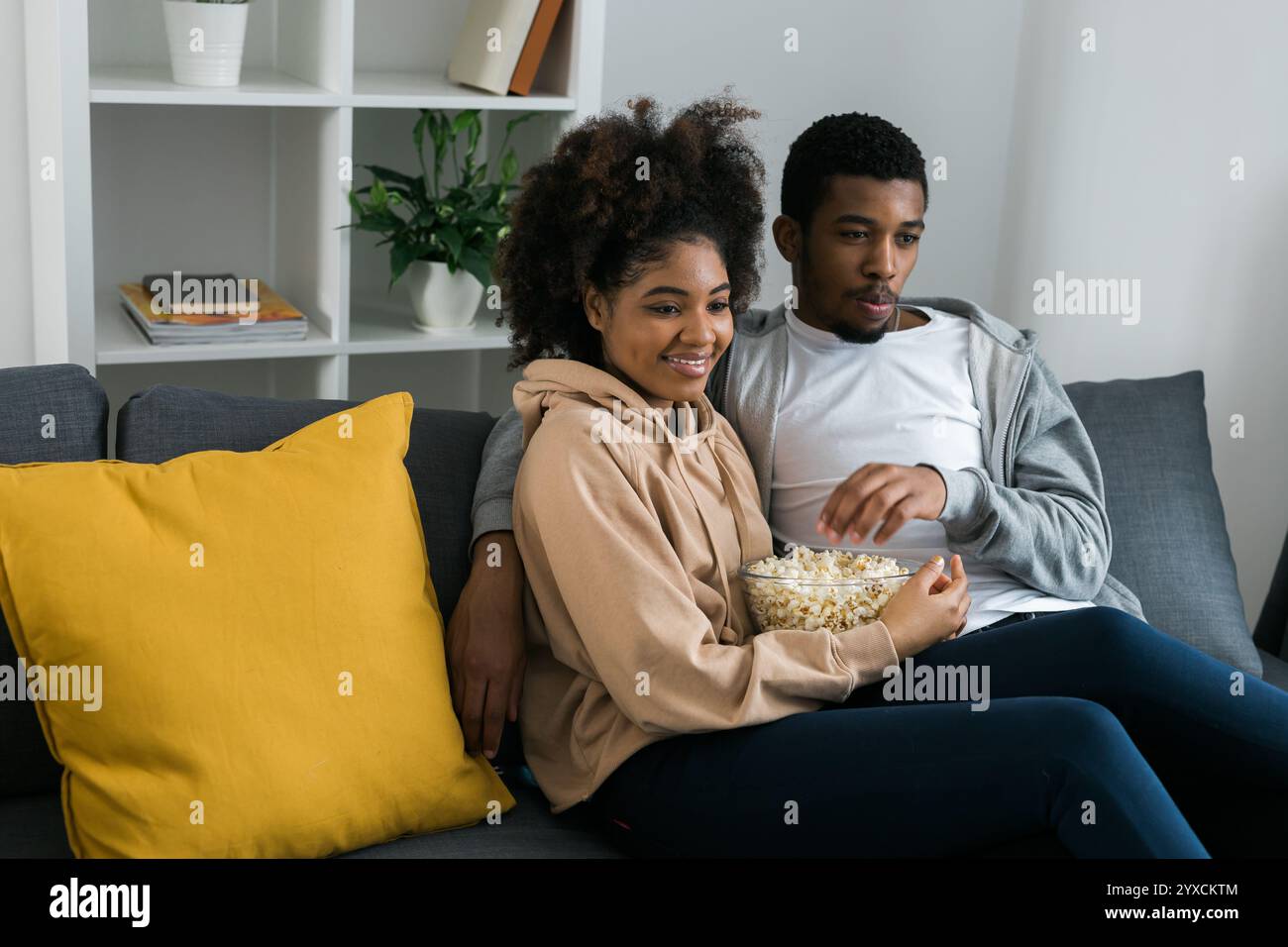 African american couple wife husband watching movie. Family pastime and leisure, watch ...