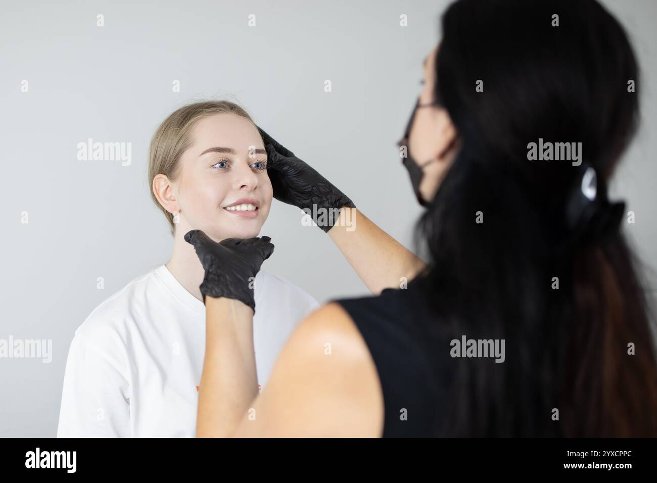 Ladies enjoy permanent makeup pampering session at beauty salon Stock ...