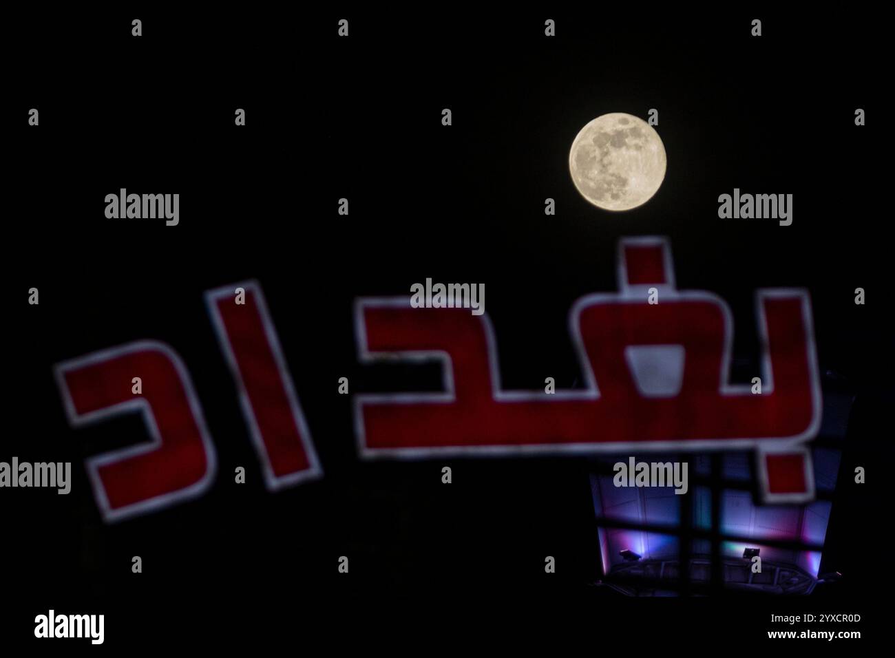 The full moon rises above Baghdad amusement park in Baghdad, Iraq ...