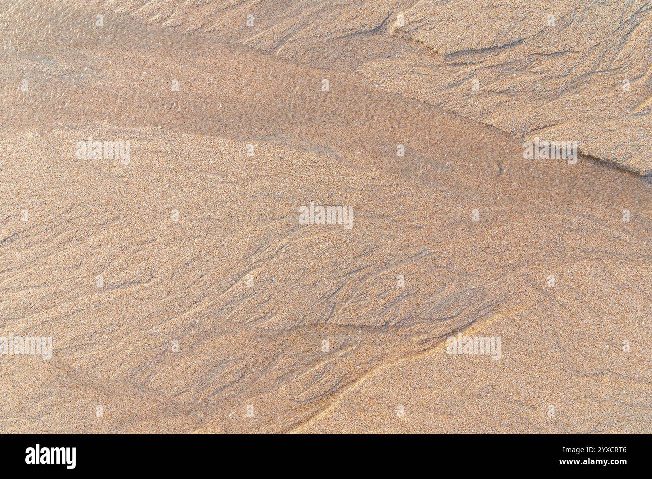 Abstract shapes and patterns in the grainy sand and flowing water on ...
