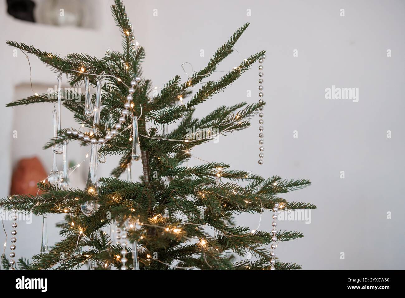 Elegant Christmas Tree Decorated with Strands of Beads and Warm Lights Stock Photo - Alamy