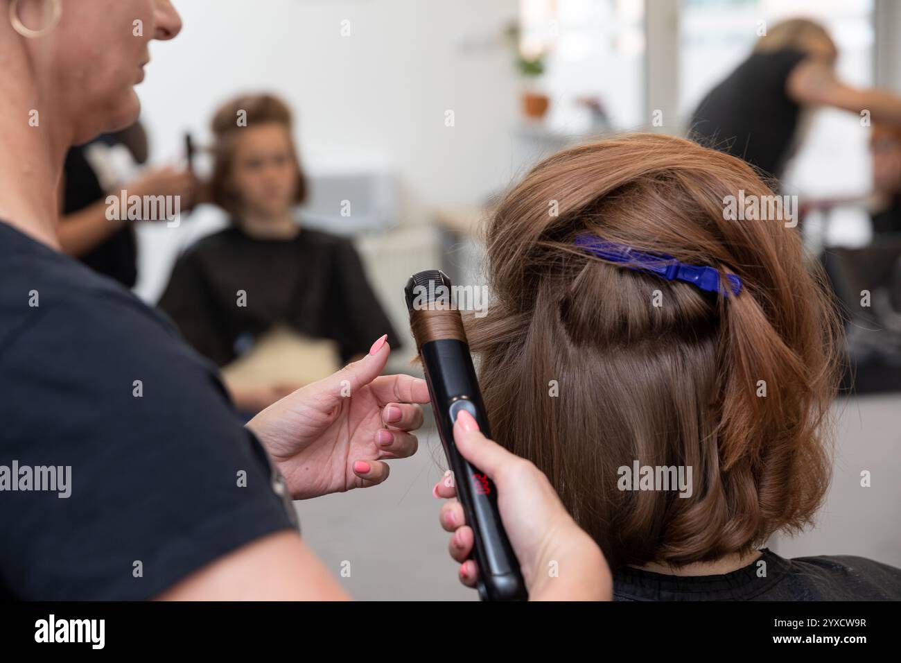 A Professional Hair Styling Session in a Modern, Chic Salon Environment for Clients Stock Photo ...