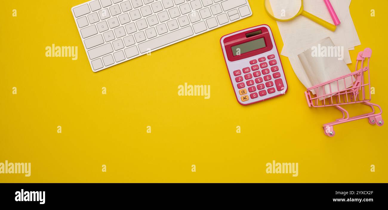 White wireless keyboard, stack of paper receipts and magnifier on ...