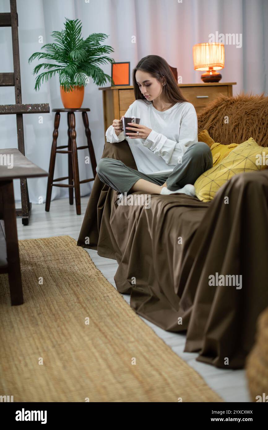 Experience Cozy Indoor Relaxation with a Woman Embracing a Warm and ...