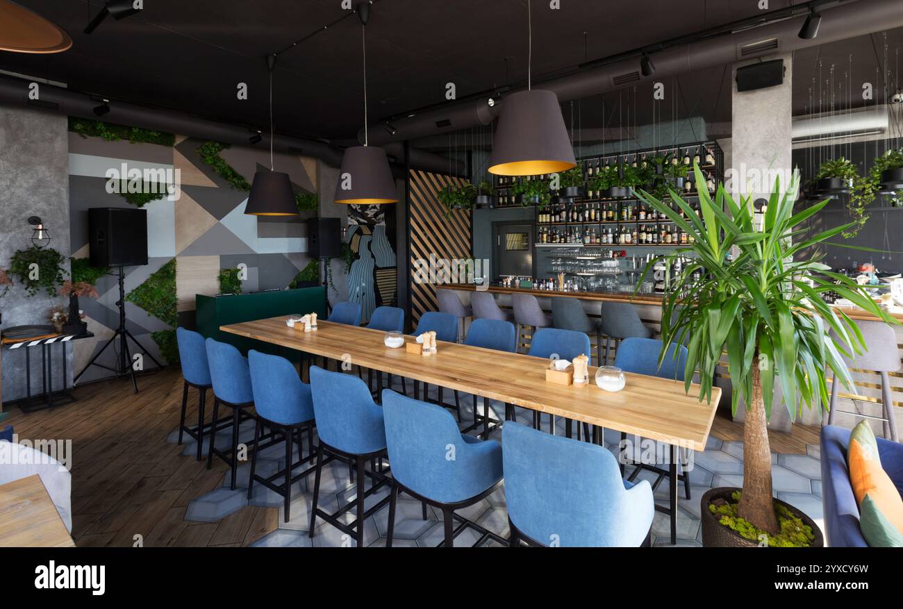 Cute restaurant interior with sofas and wooden tables Stock Photo - Alamy