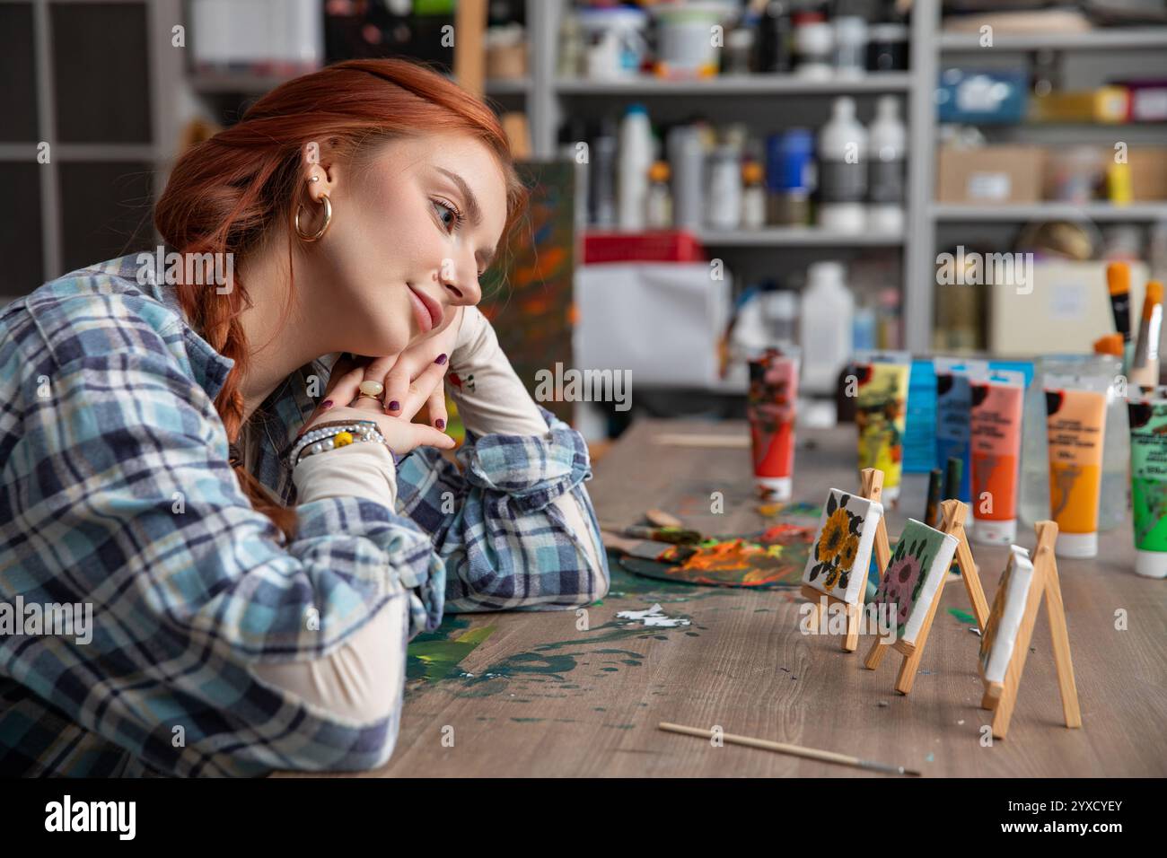 A Creative Artist in Her Studio Deeply Contemplating Various Art ...
