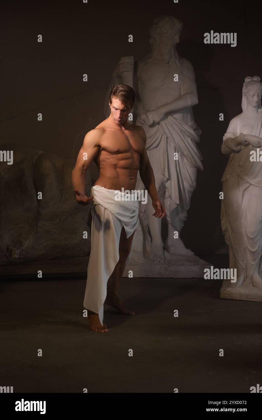 A sculptor's workshop, a muscular man in a tunic among antique statues ...