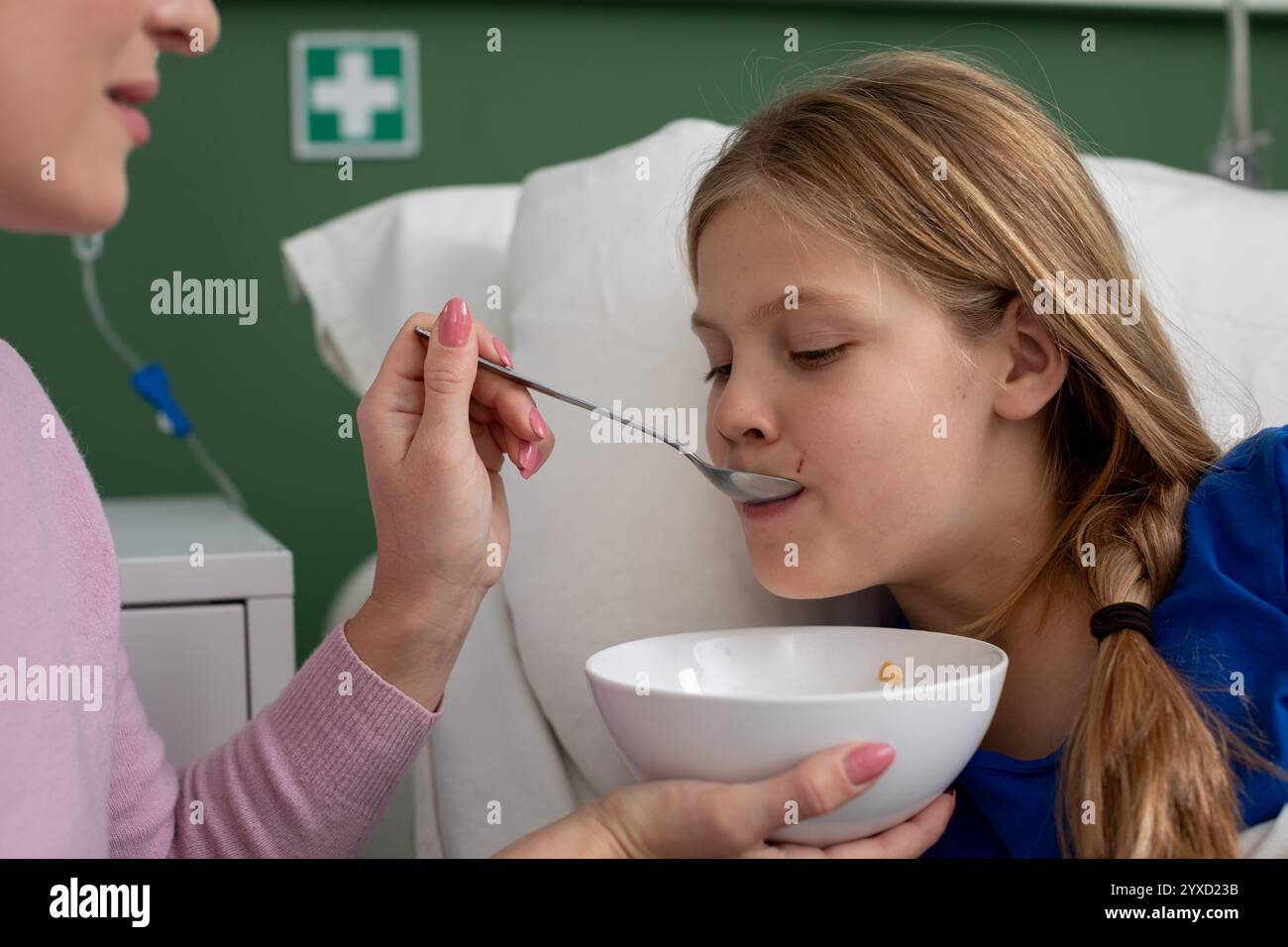 Caring Moment A Child Being Tenderly Fed While in a Hospital Room with ...