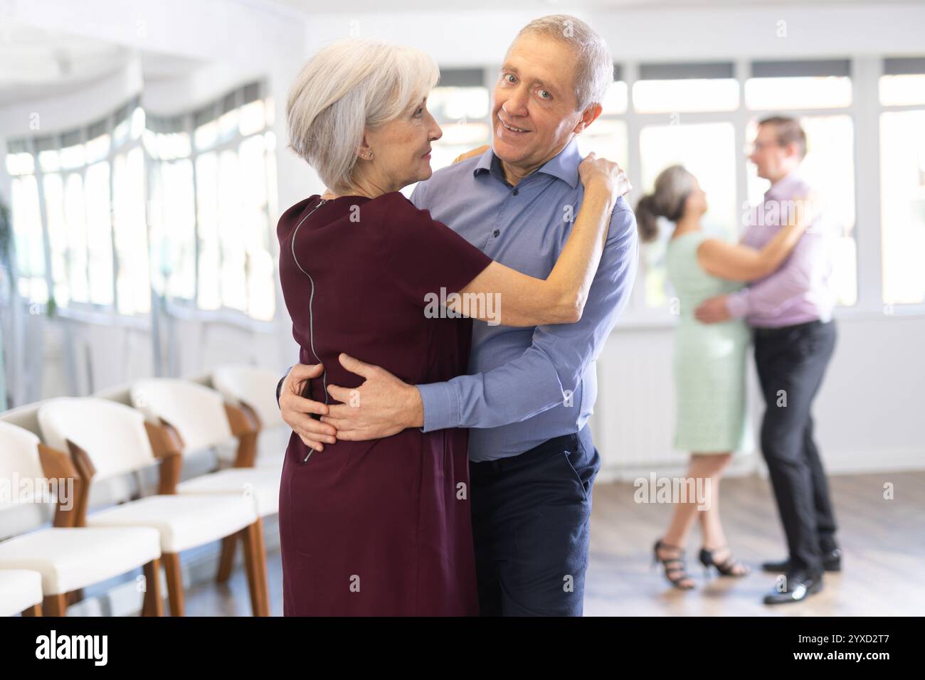 Elderly woman is dancing slow unhurried dance in hugs arms of her ...