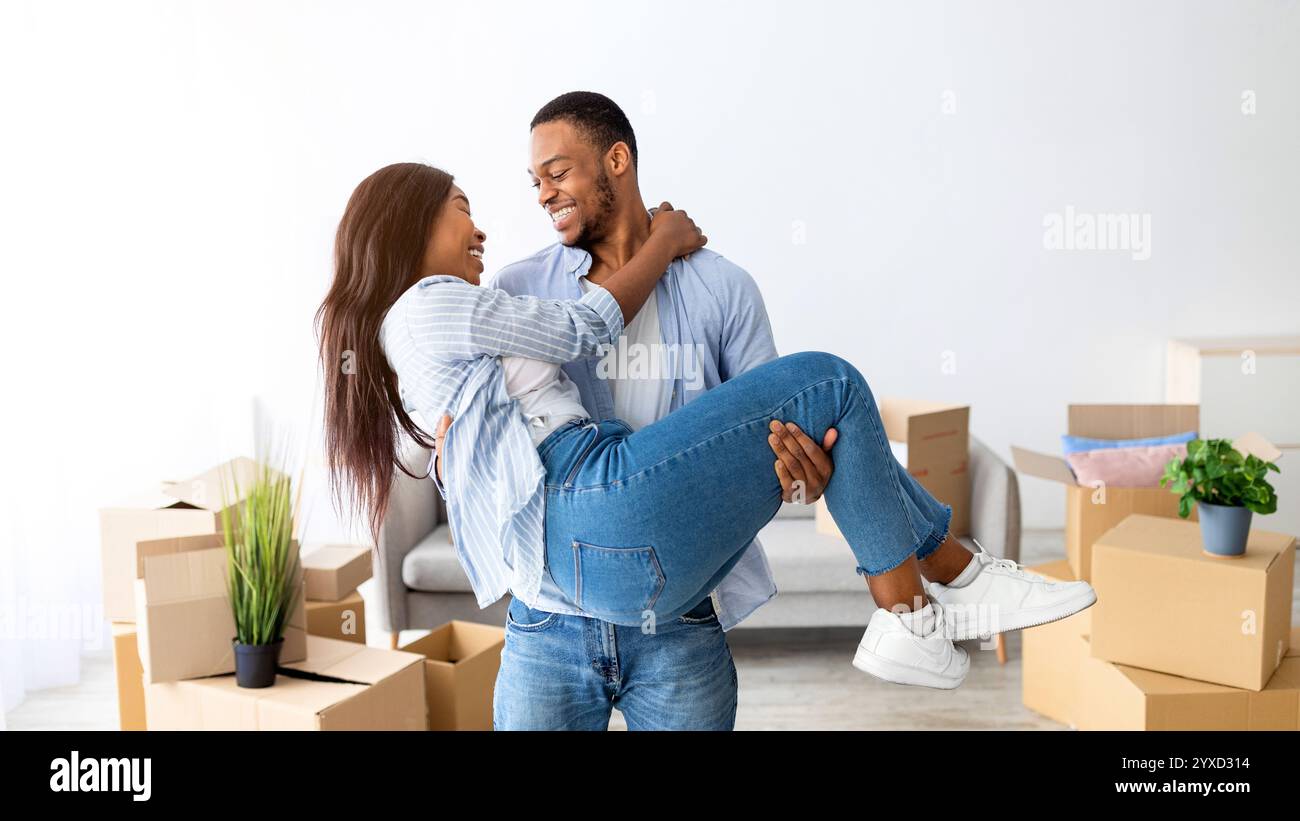 Happy moving day. Loving african american couple celebrating relocation ...