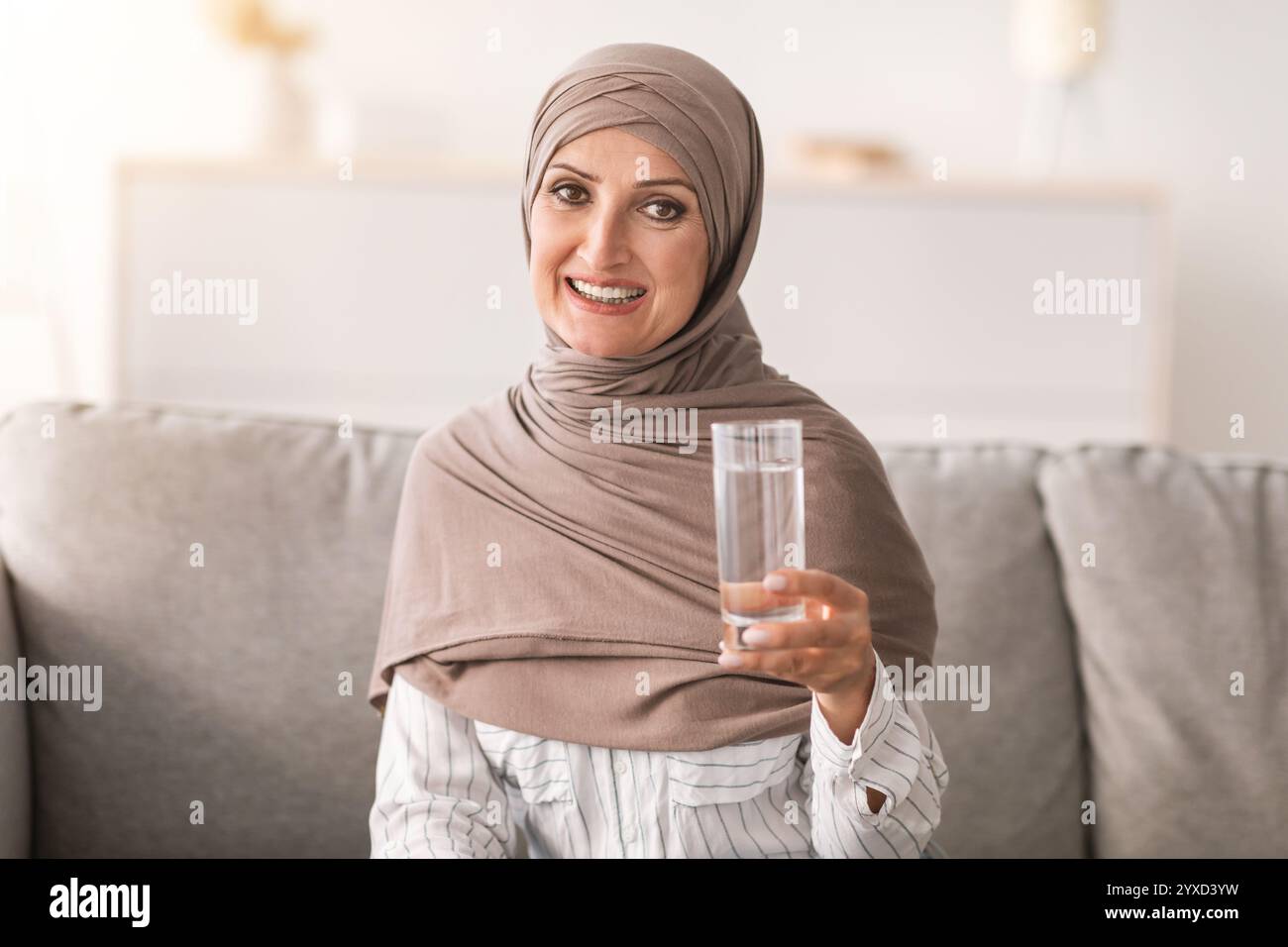 Muslim Woman Posing Holding Glass Of Water Drinking At Home Stock Photo ...