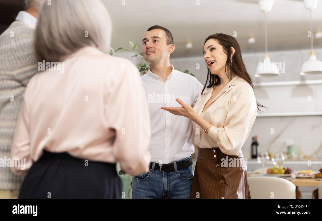 Joyful woman introducing boyfriend to elderly parents at home Stock ...