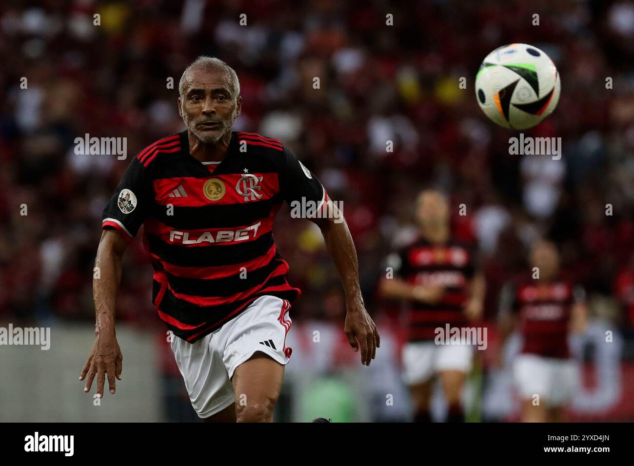 Brazilian former soccer player Romario eyes the ball during Adriano's ...