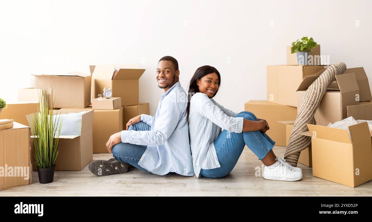 Happy spouses moving to new apartment or house. Loving african american ...