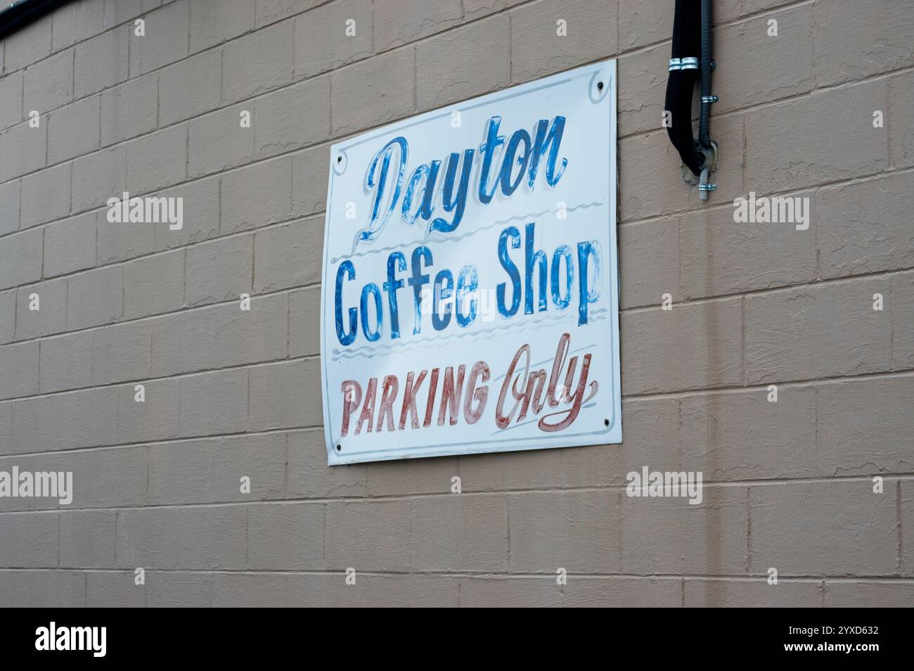 Dayton, TN USA - 12-14-2024 - Worn and faded sign on a painted block ...