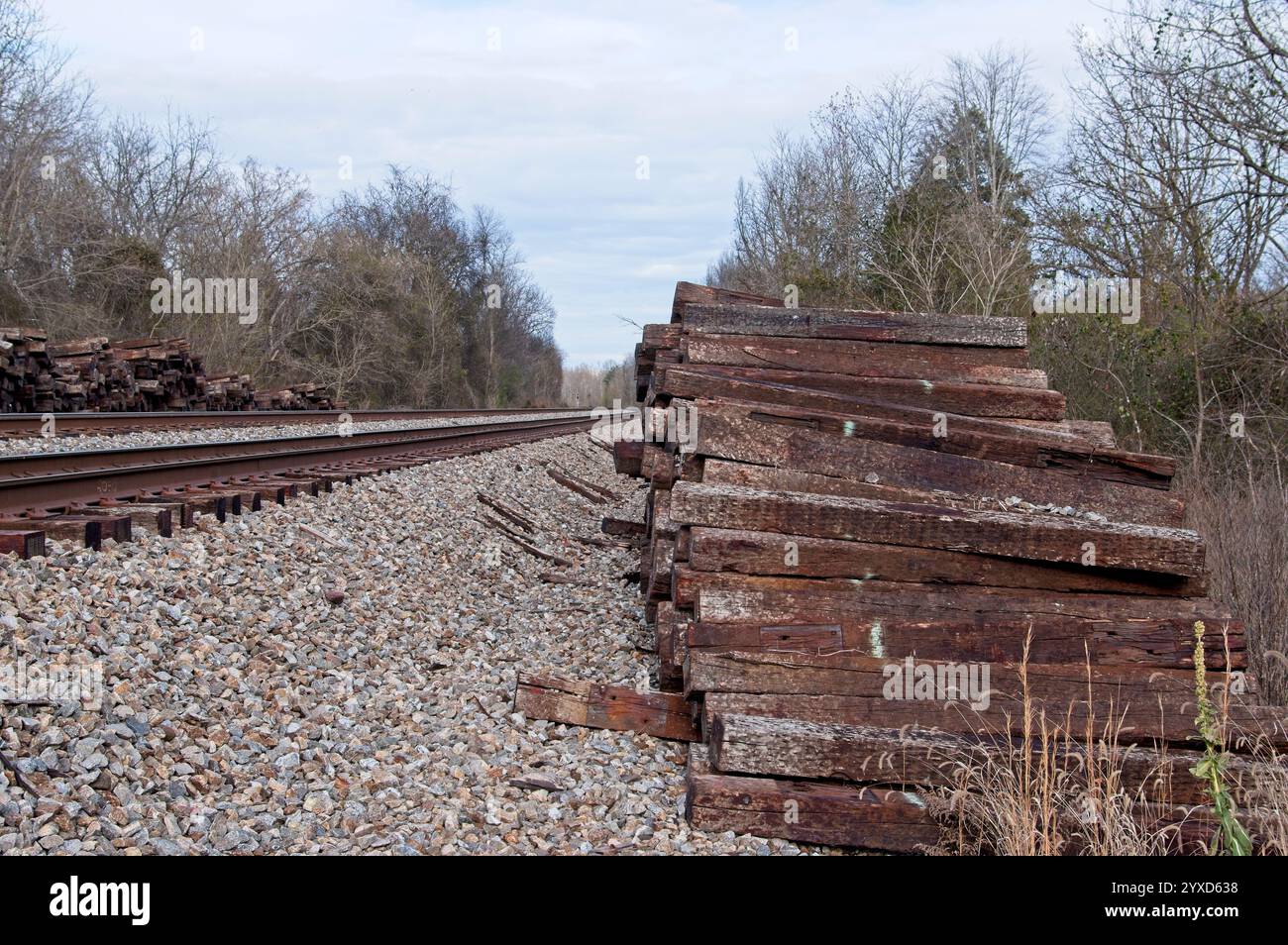 Stacks of old railroad ties next to tracks Stock Photo - Alamy