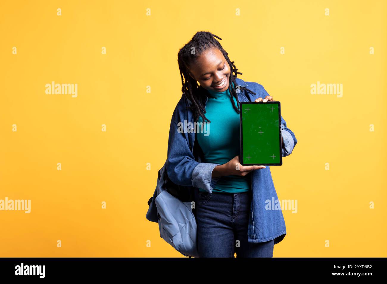 Upbeat african american woman presenting tablet with chroma key display ...