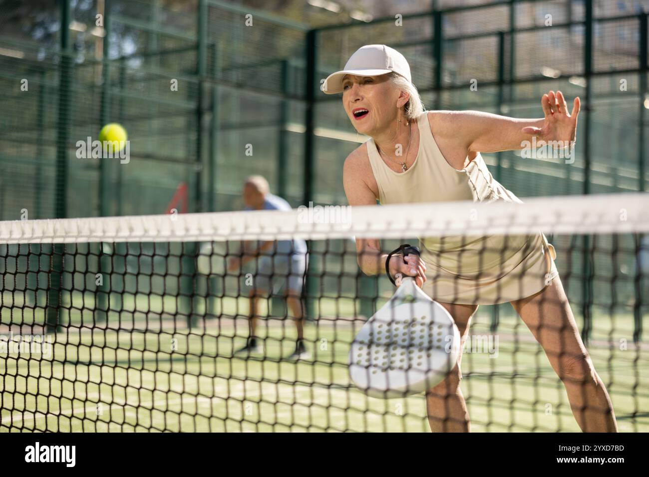 Old woman playing Padel Tennis in open-air tennis court Stock Photo - Alamy