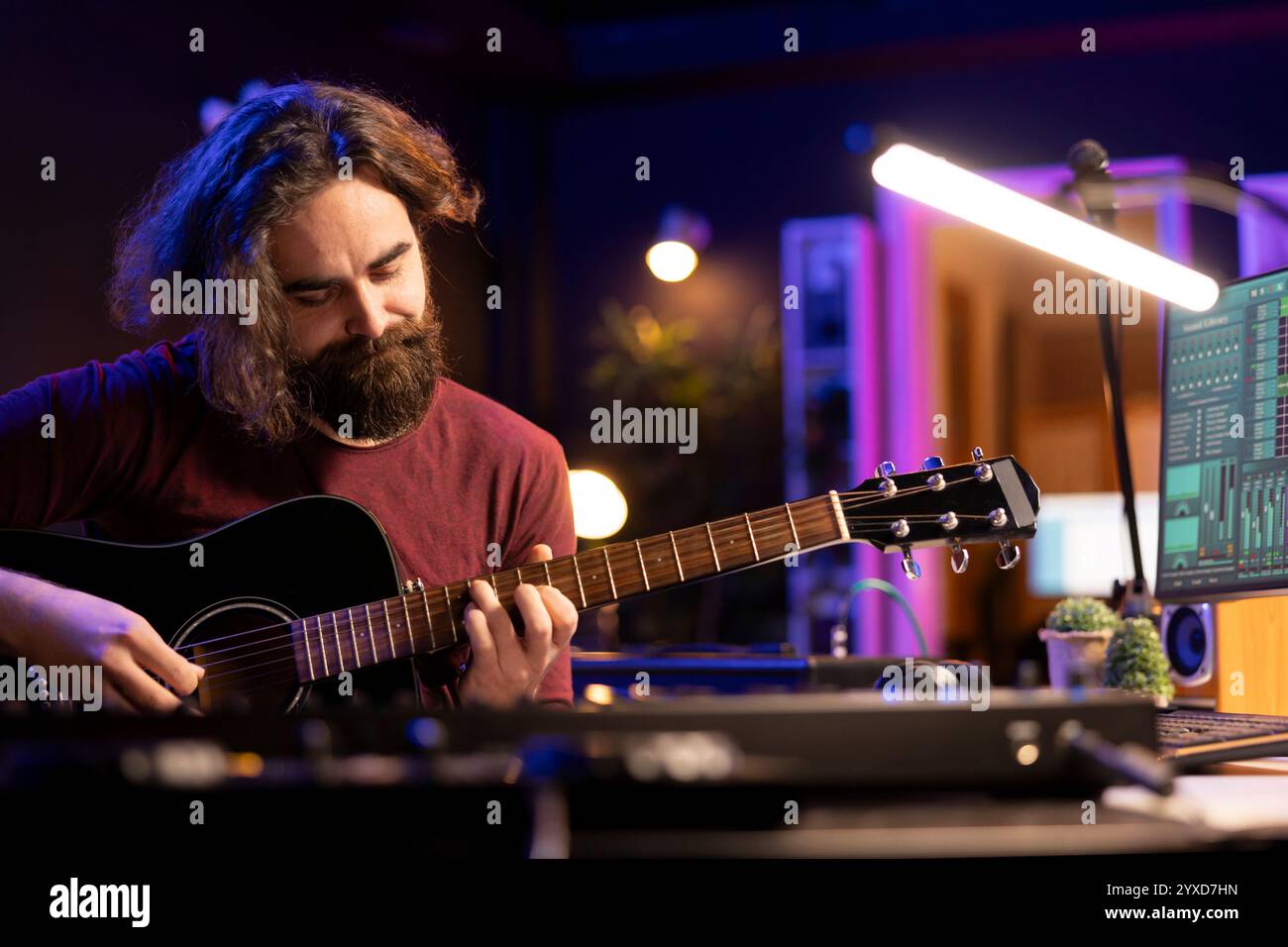 Songwriter musician recording sounds on daw software with guitar ...