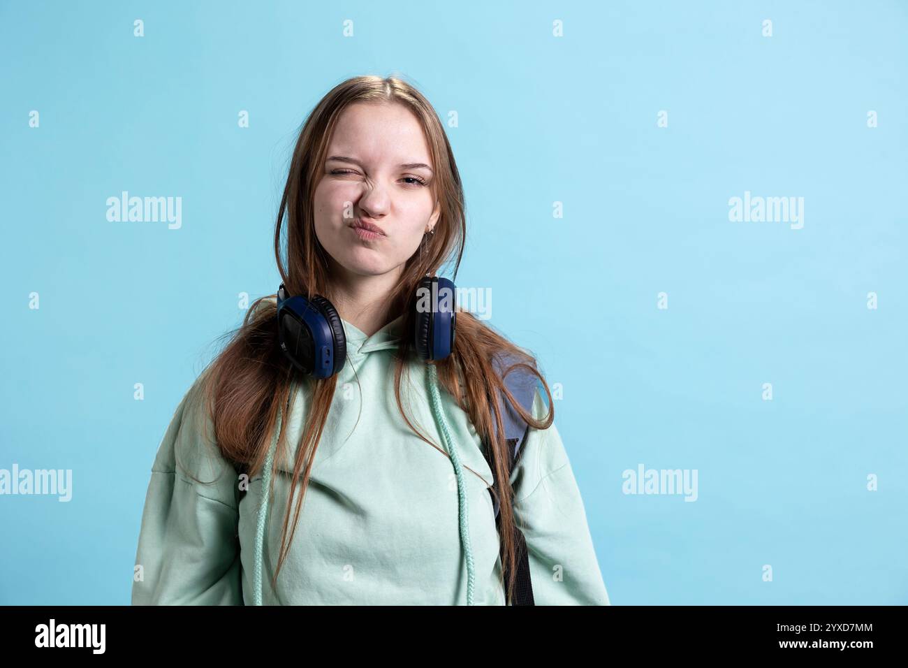Young person doing goofy childish facial expressions, acting amusing ...