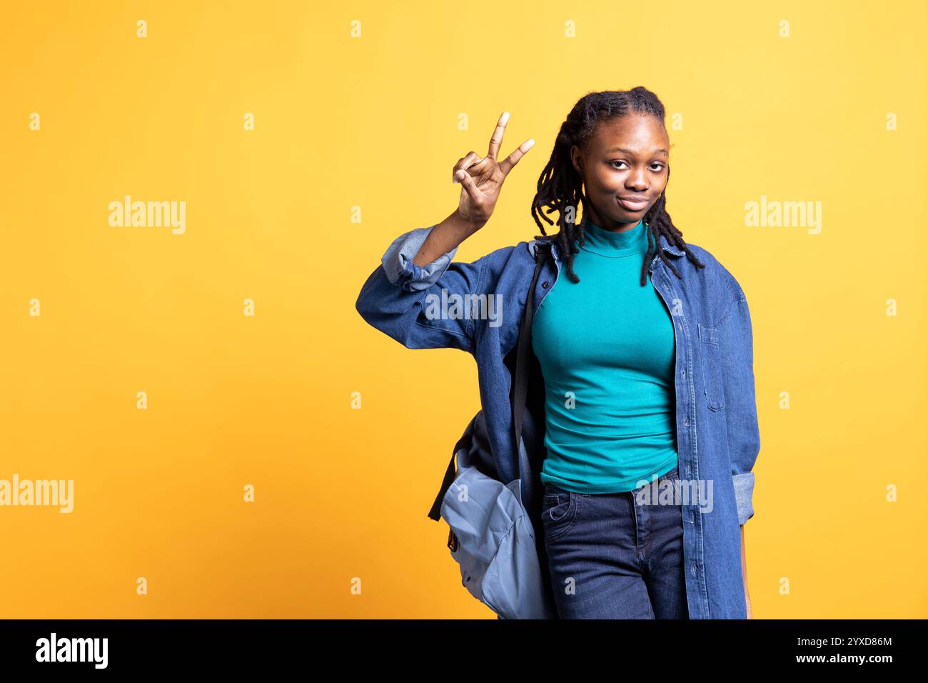 African american happy young woman smiling, doing victory hand sign ...