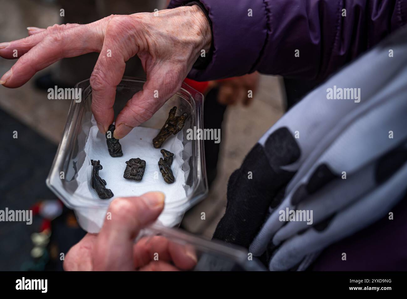 A woman is seen showing her miniature lead nativity scene stored inside ...