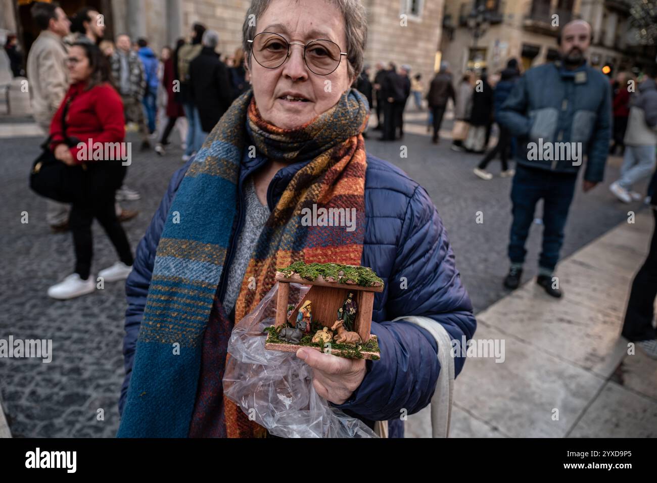 A woman is seen showing her protest nativity scene. Called by the ...