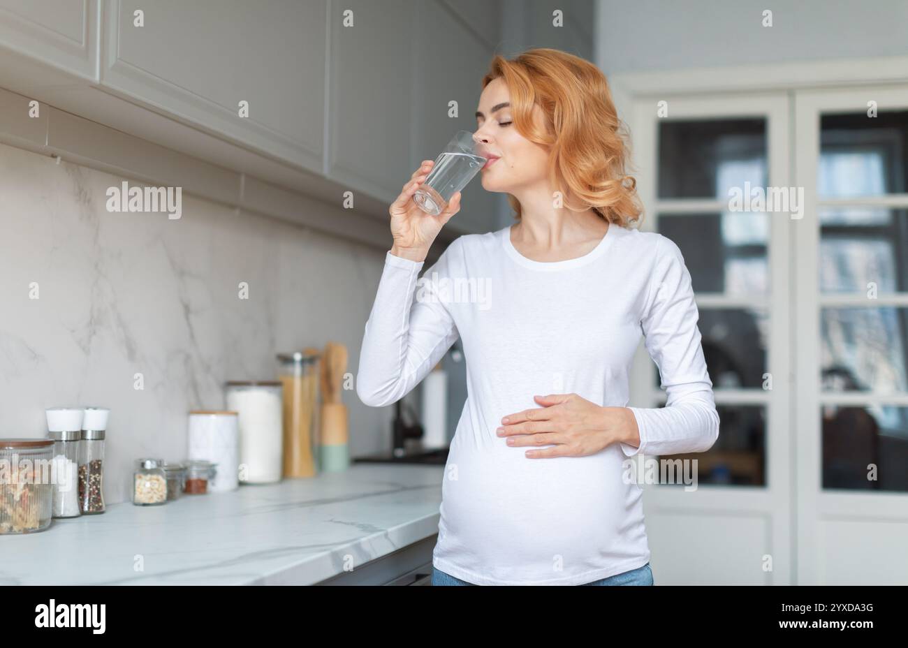 Pregnant mom drinking water hi-res stock photography and images - Alamy