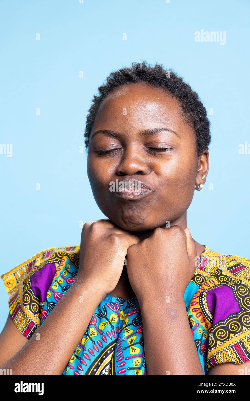 African American girl full of enthusiasm pulls silly poses for the ...