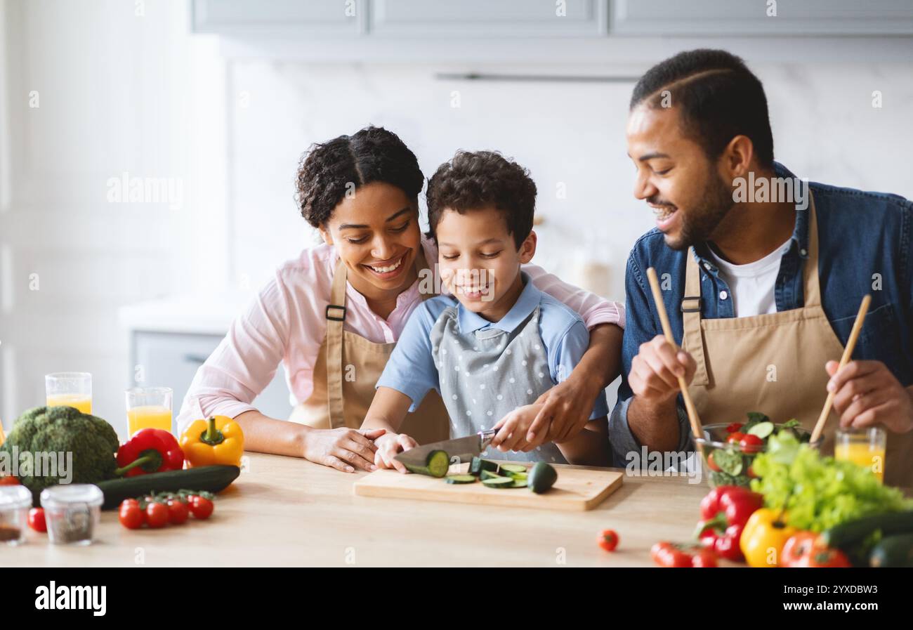 Family cooking together in a bright kitchen while sharing love and ...