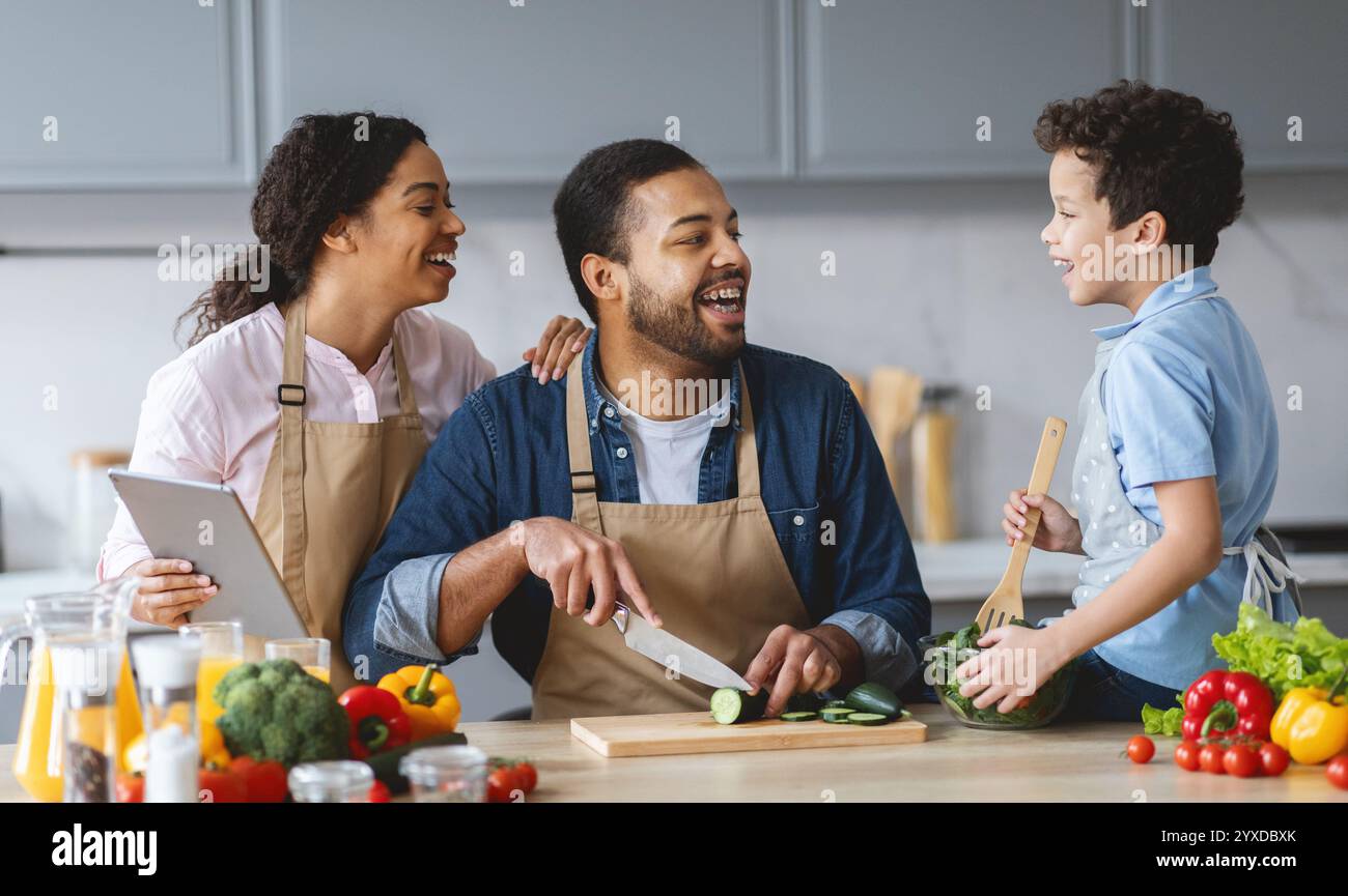 Family enjoys quality time while cooking together in a bright kitchen ...