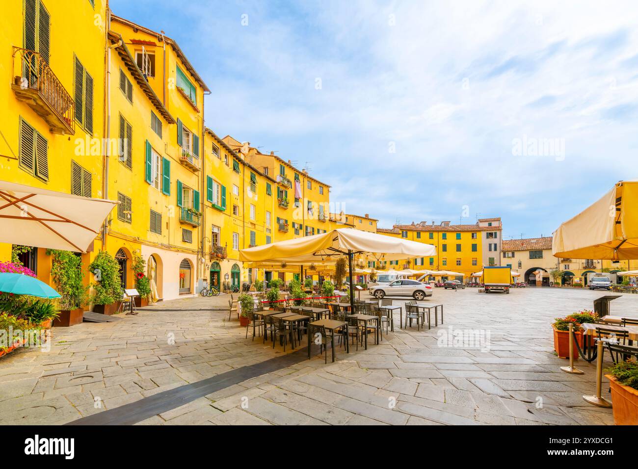 Sidewalk cafes and shops inside the colorful circular Piazza del ...