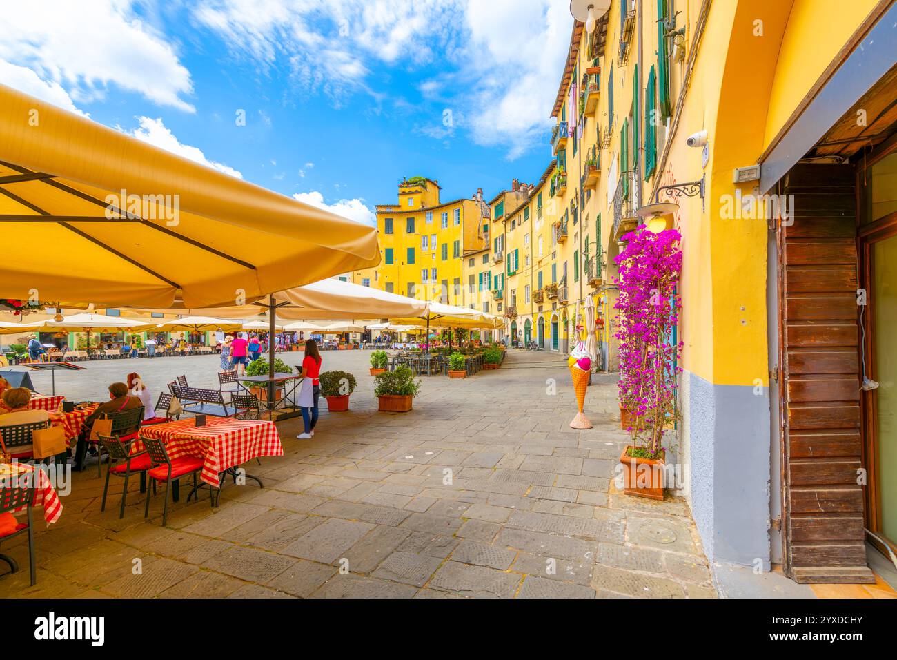 Sidewalk cafes, gelato shops and stores at the colorful circular Piazza ...