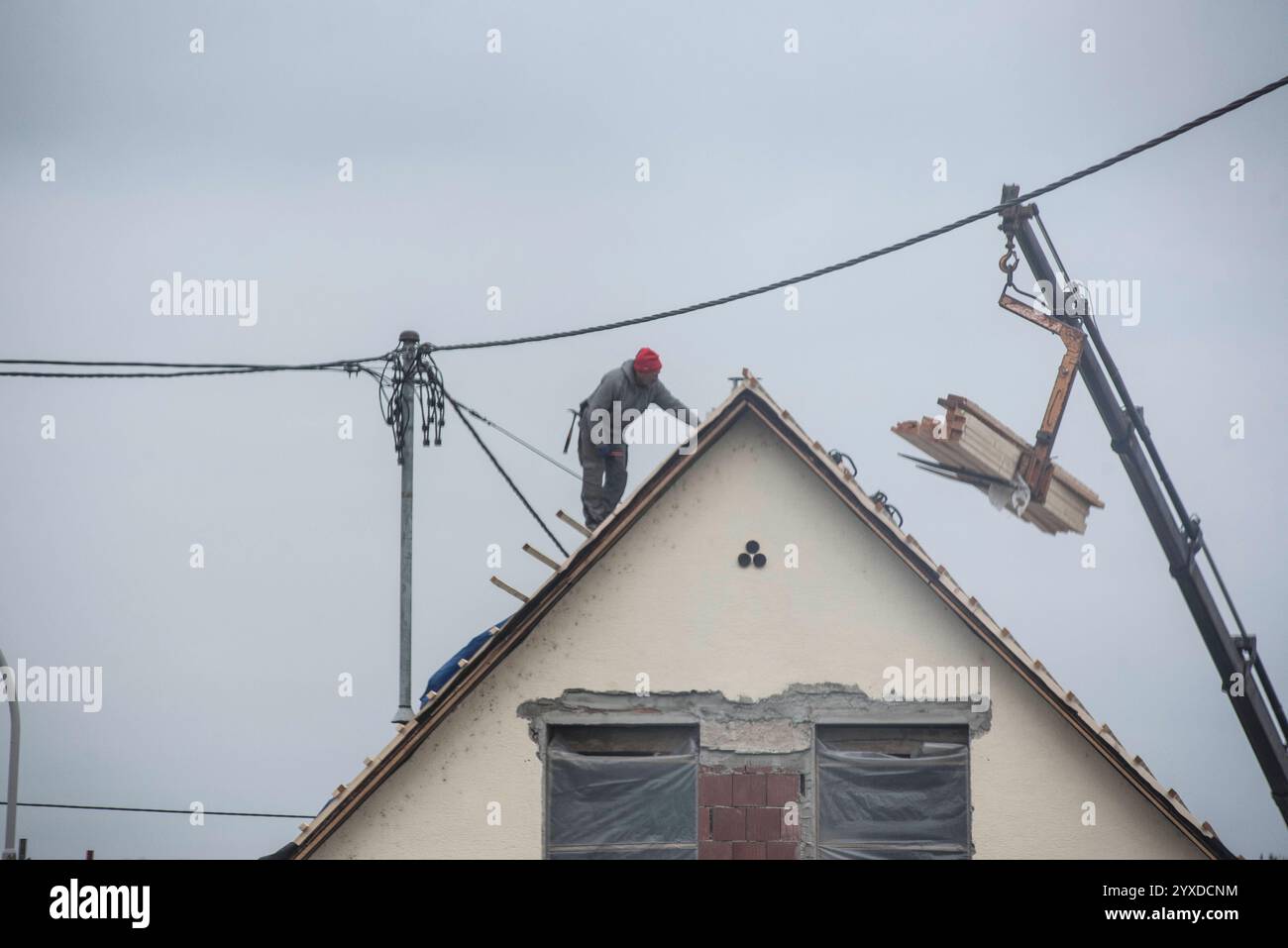 construction worker at topping out or roofing ceremony, when finishing ...