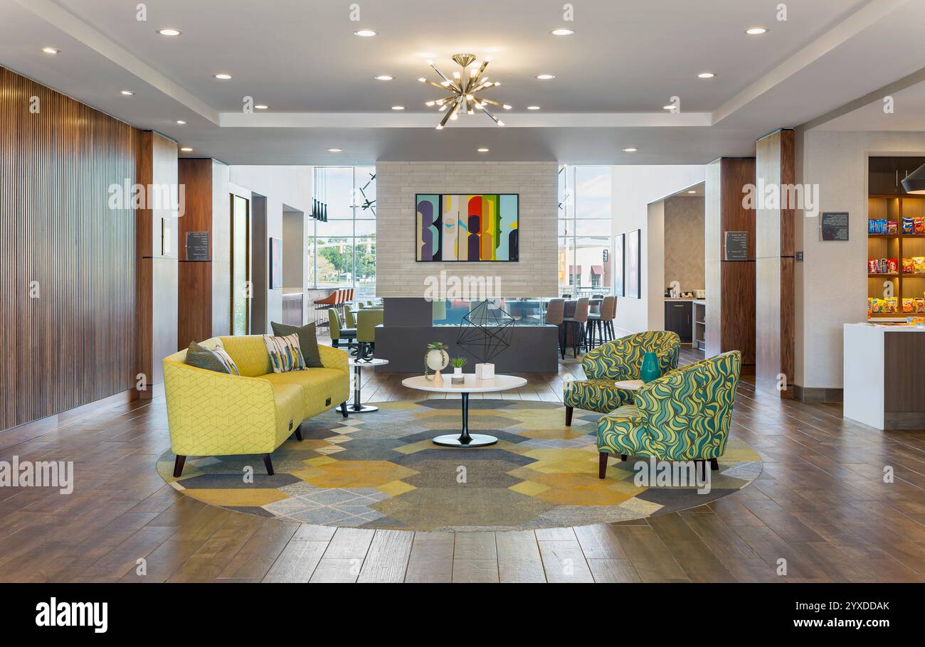 Round seating area in hotel lobby with dining area in background Stock ...
