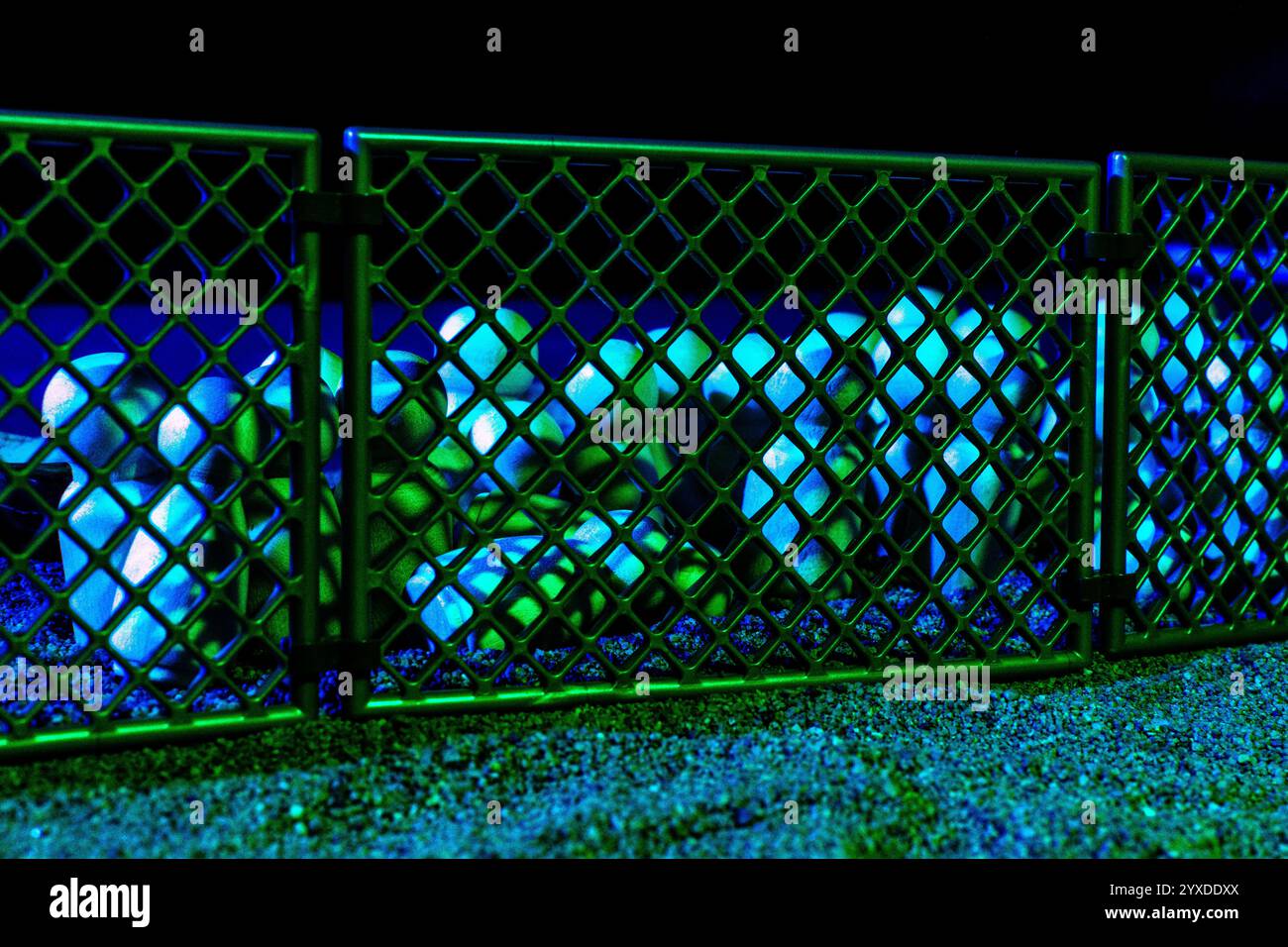Figures and Boats Encased Behind a Fence with Green Accents Stock Photo ...