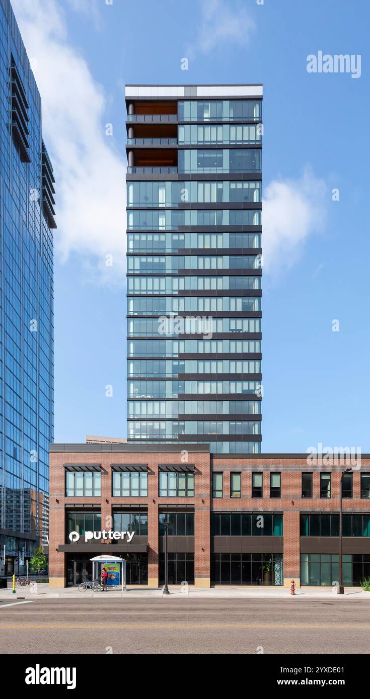A residential glass apartment building sits above the brick building ...