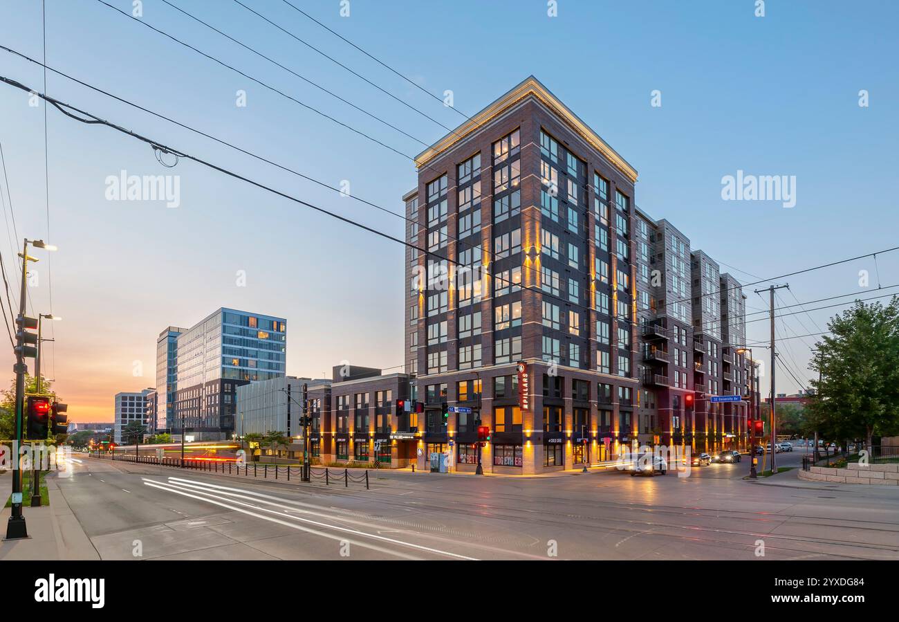 Apartment building on corner with light rail tracks in the street and ...